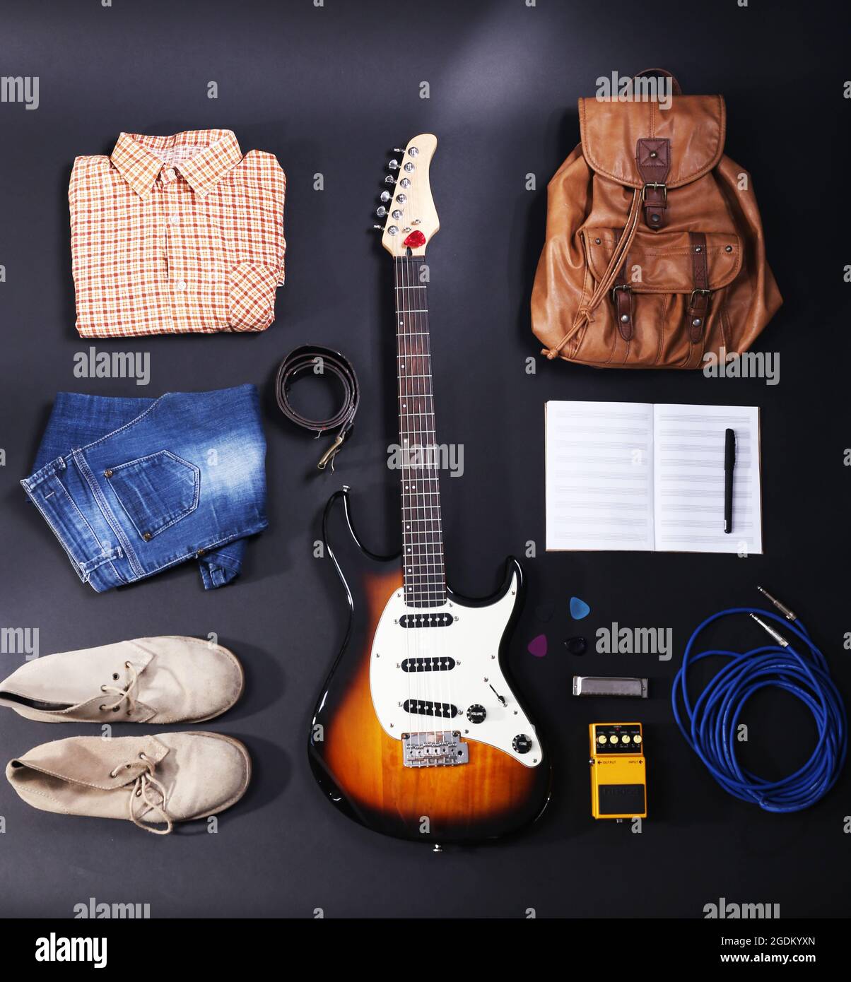 Musical equipment, clothes and footwear on dark background Stock Photo ...