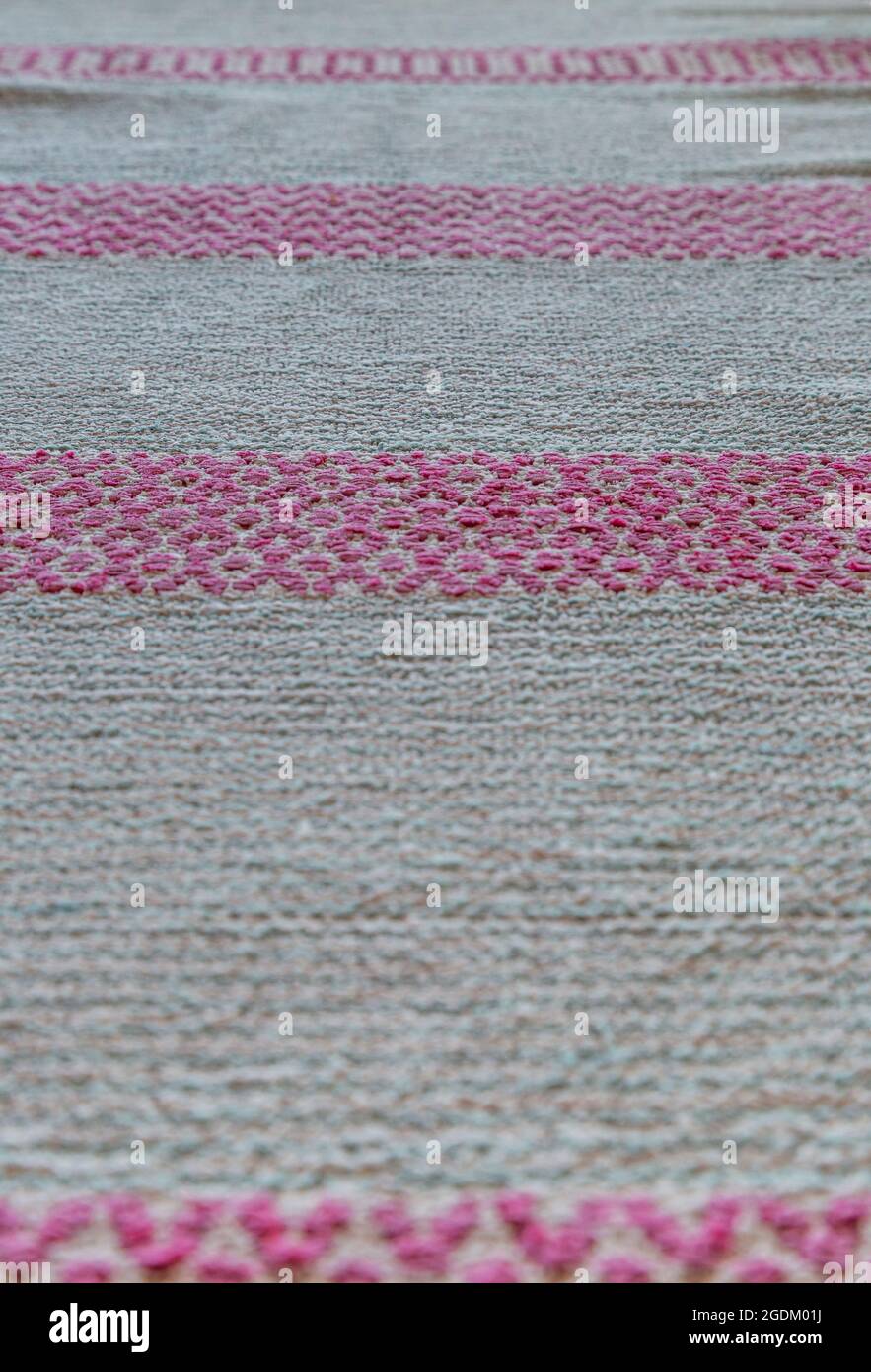Close-up of a rag rug viewed from the front, tilted angle. Abstract ...