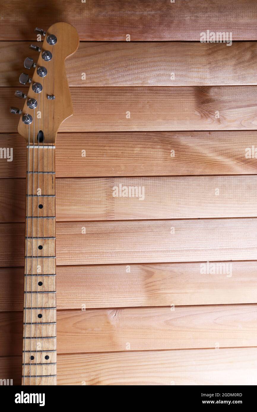 Guitar fretboard on wooden background Stock Photo - Alamy