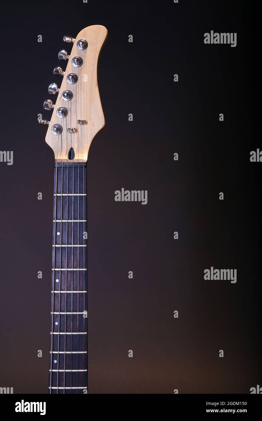 Guitar fretboard on dark background Stock Photo - Alamy