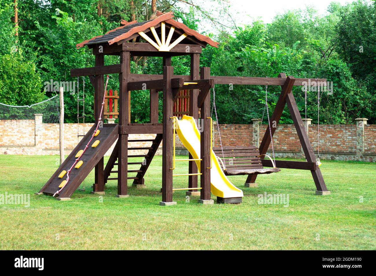 Landscape. Wooden playground with swings, slide and stairs on the ...