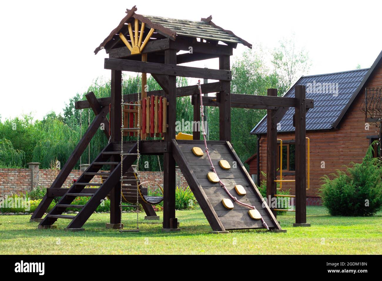 Landscape. Wooden playground with swings, slide and stairs on the ...