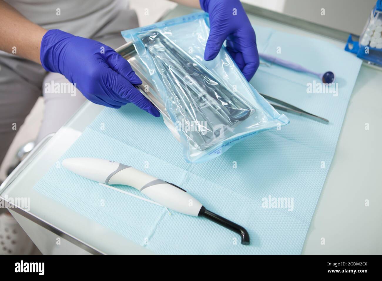Unrecognizable dentist unpacking sterilized instruments Stock Photo - Alamy