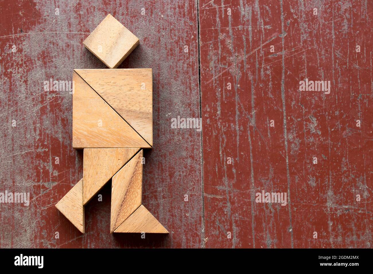 Tangram puzzle in man walking shape on red old wood background Stock ...