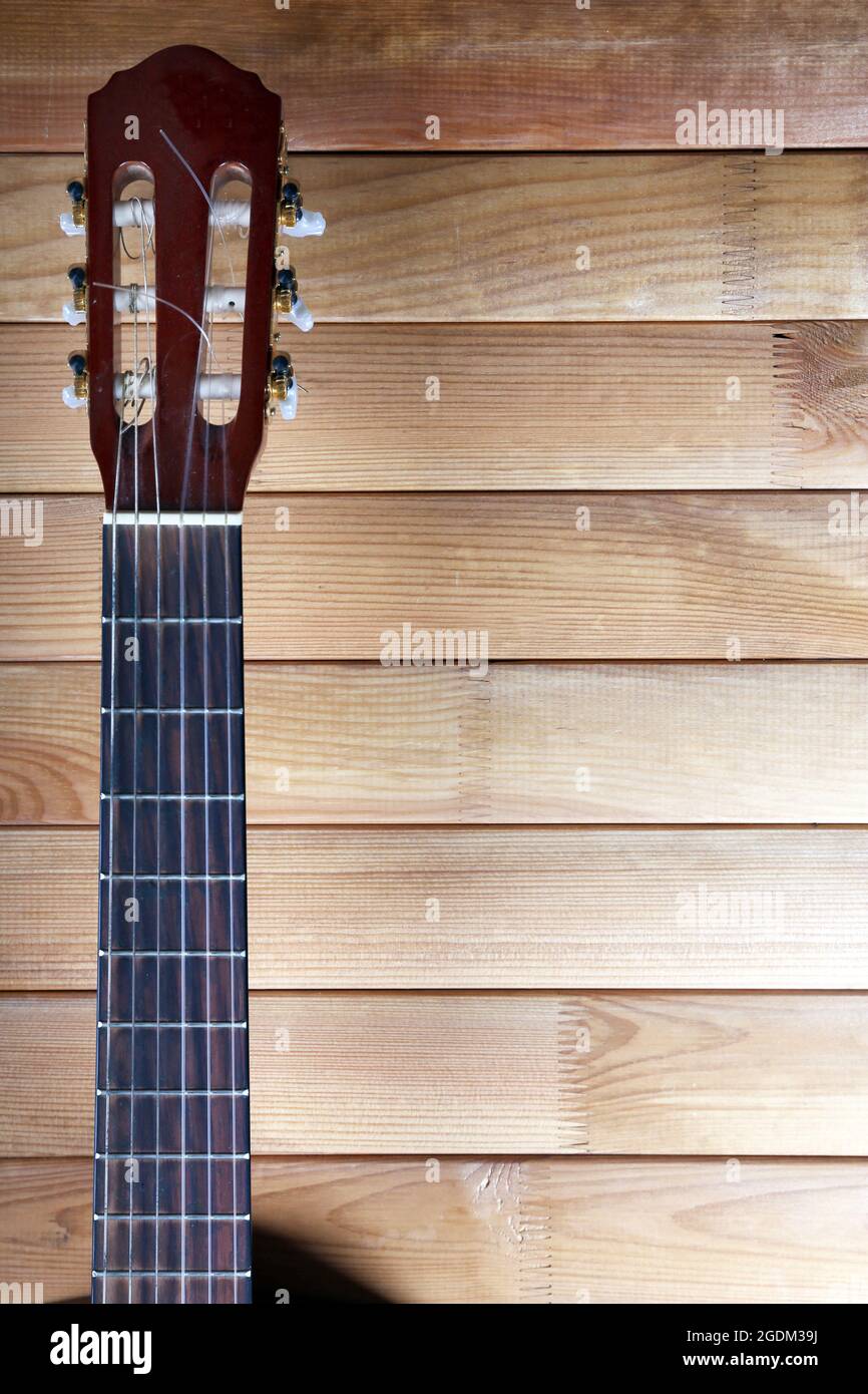 Guitar fretboard on wooden background Stock Photo - Alamy