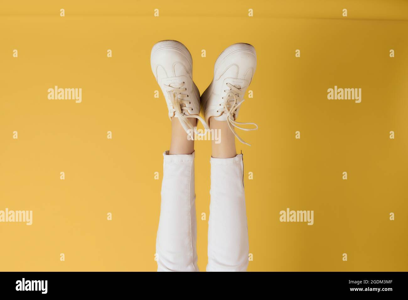womens inverted legs upside down white sneakers fashion Stock Photo - Alamy
