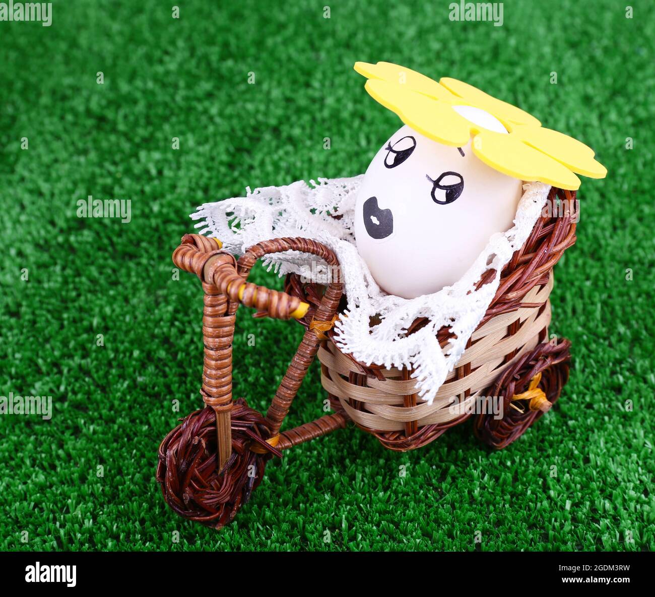 Egg riding bicycle on green background Stock Photo - Alamy