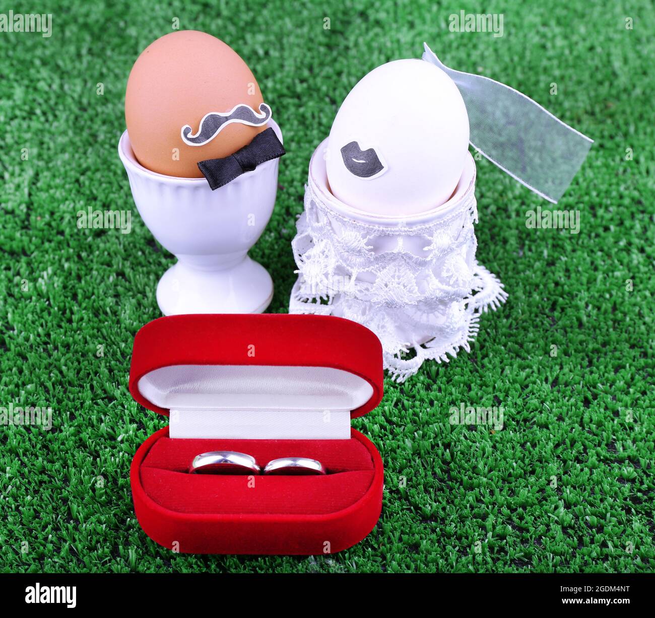 Bride and bridegroom eggs in egg cups on green background Stock Photo ...
