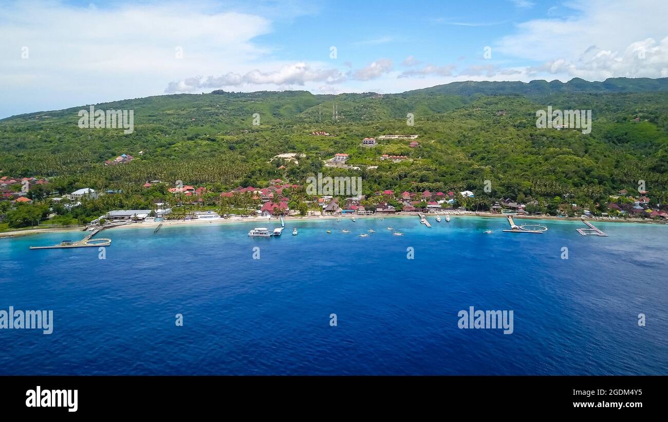 Epic aerial top down of crystal clear coral reefs under wooden pier on ...