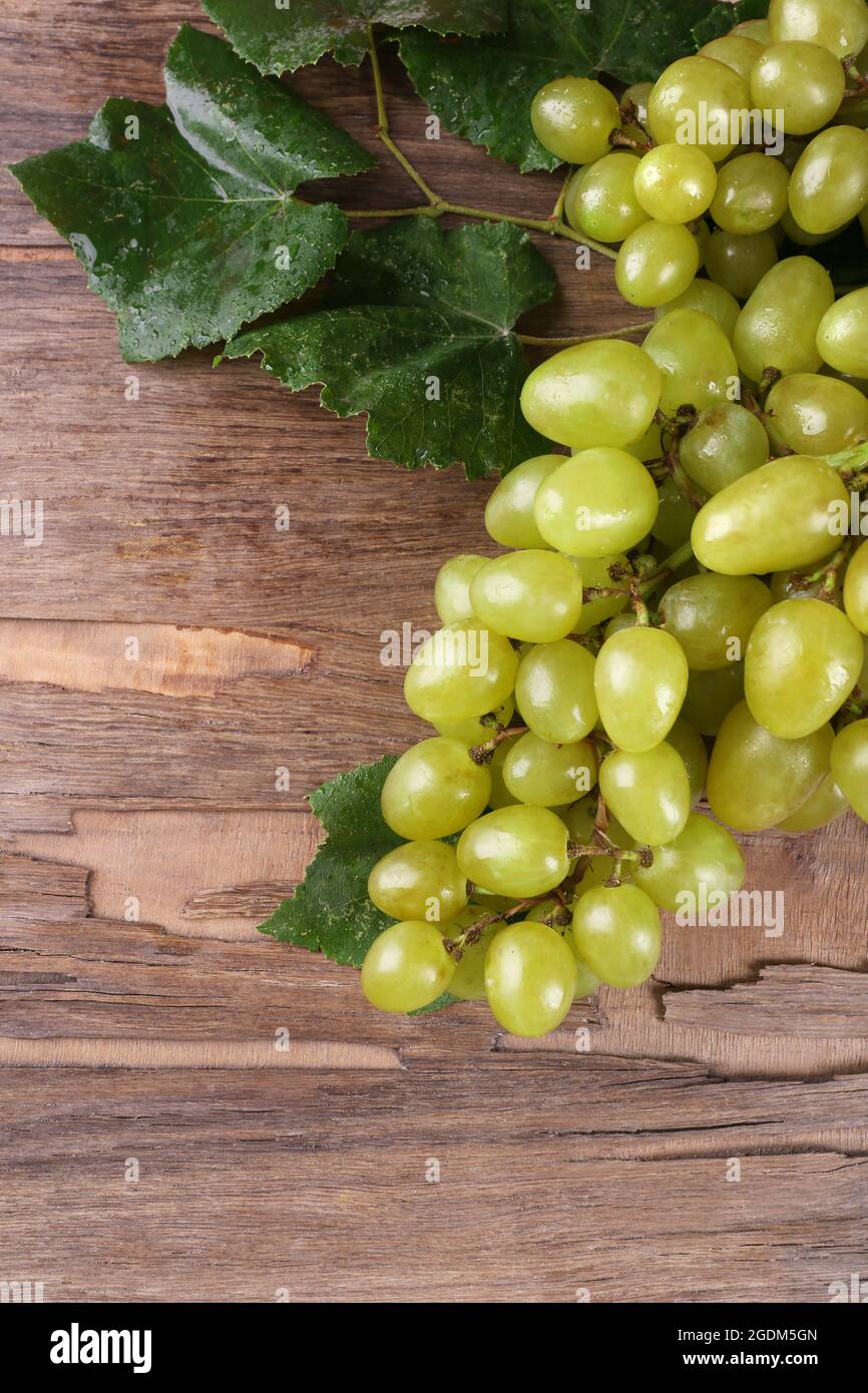 Bunch of grape on wooden background Stock Photo - Alamy