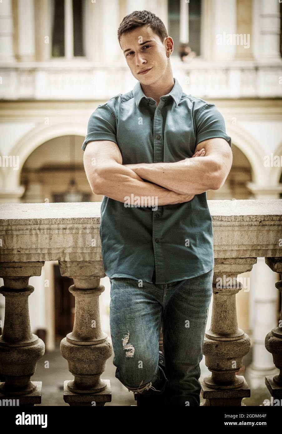 Young Man Leaning Against Marble Staircase Railing Stock Photo - Alamy
