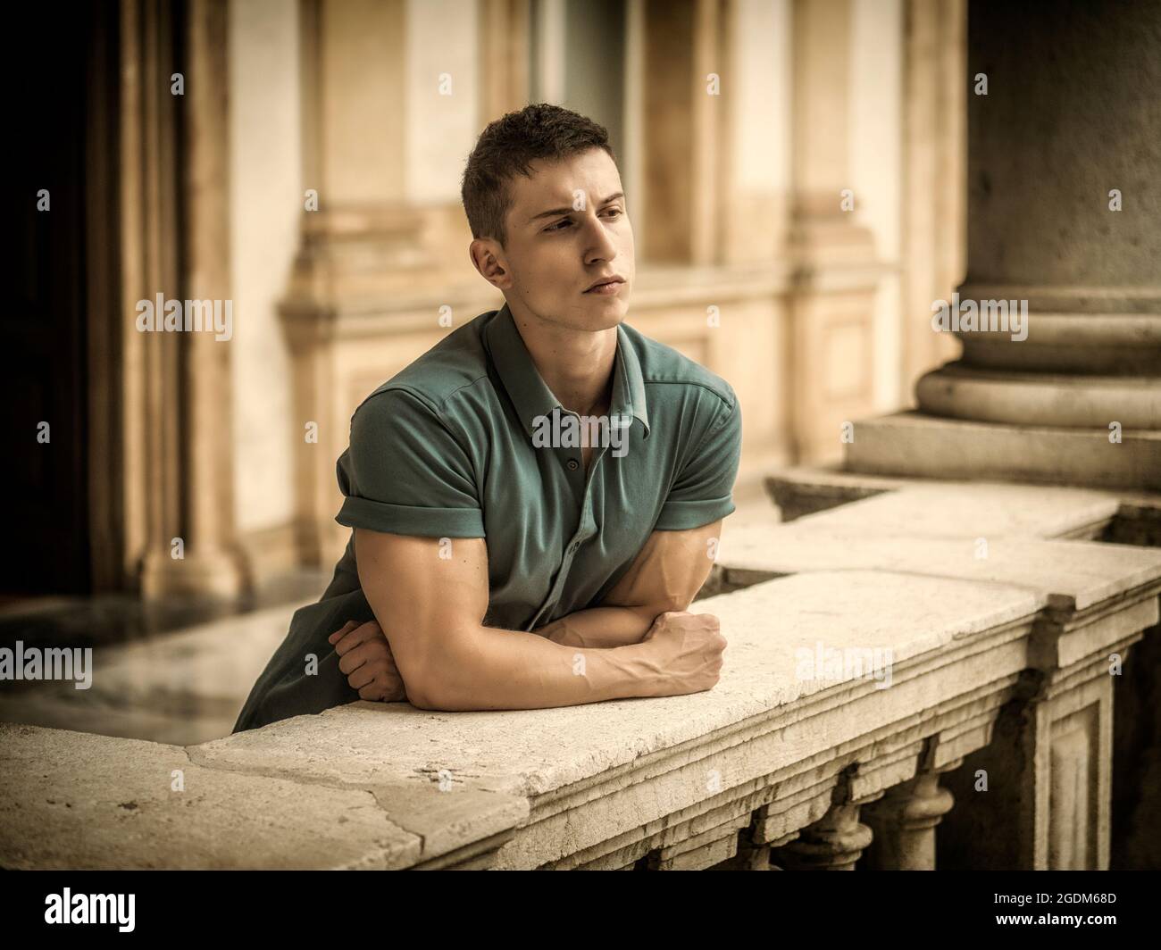 Young Man Leaning Against Marble Staircase Railing Stock Photo - Alamy