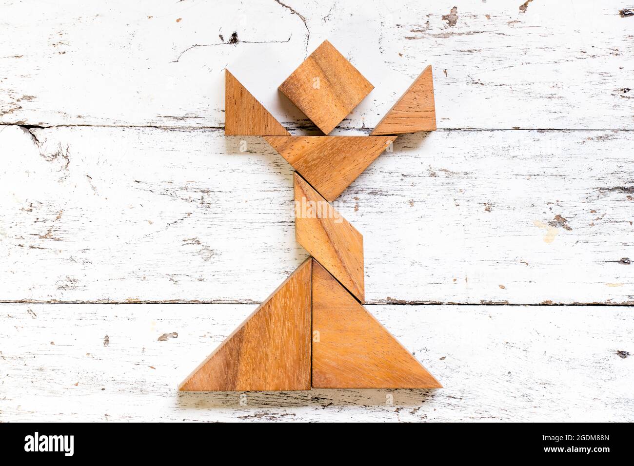 Tangram puzzle in singing girl shape on old white wood background Stock ...