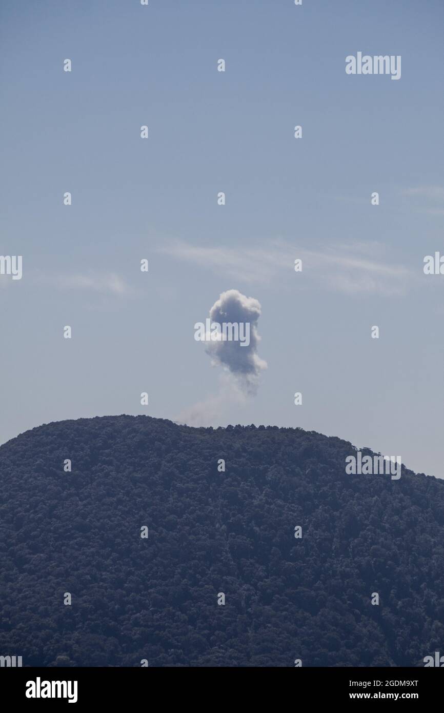 Eruption of volcano Fuego hidden behind volcan Toliman, Guatemala Stock ...