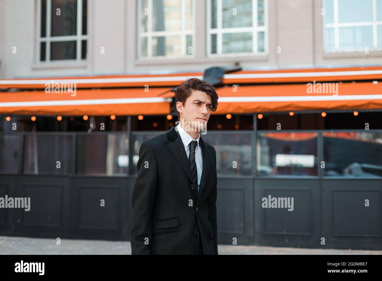Shallow focus shot of a serious young Caucasian guy dressed ...