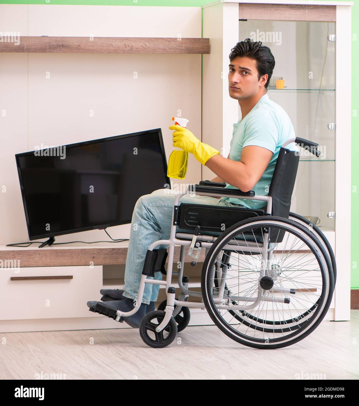 The disabled man on wheelchair cleaning house Stock Photo - Alamy