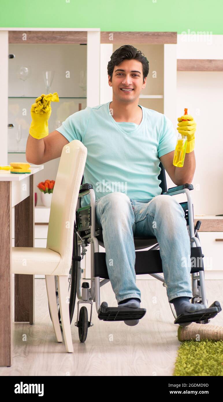 The disabled man on wheelchair cleaning house Stock Photo - Alamy