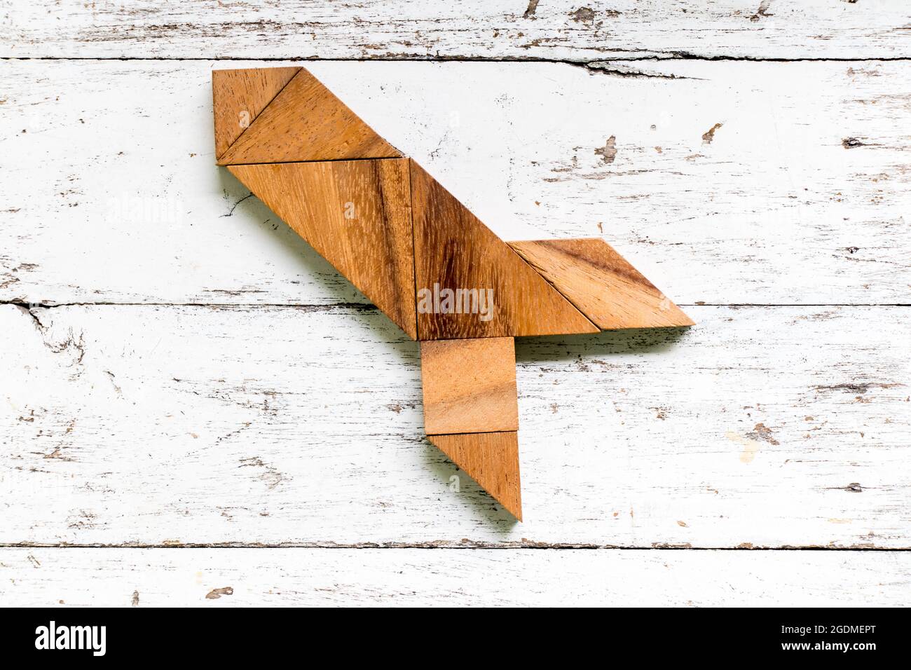 Tangram puzzle in missile or rocket shape on old white wood background ...