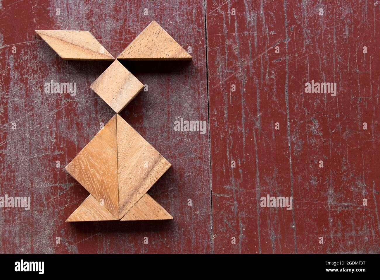 Tangram puzzle in rabbit shape on red old wood background Stock Photo ...