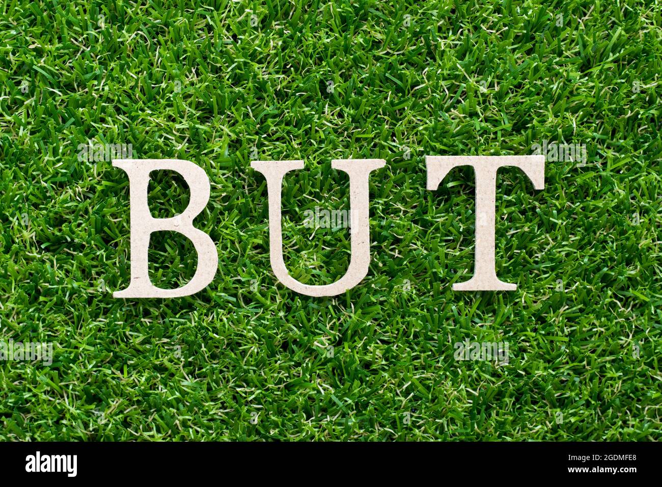 Wood alphabet in word but on artificial green grass background Stock ...