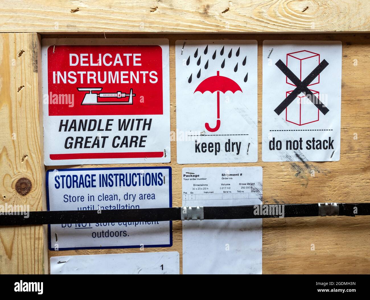 warning label beside transportation wooden box Stock Photo - Alamy