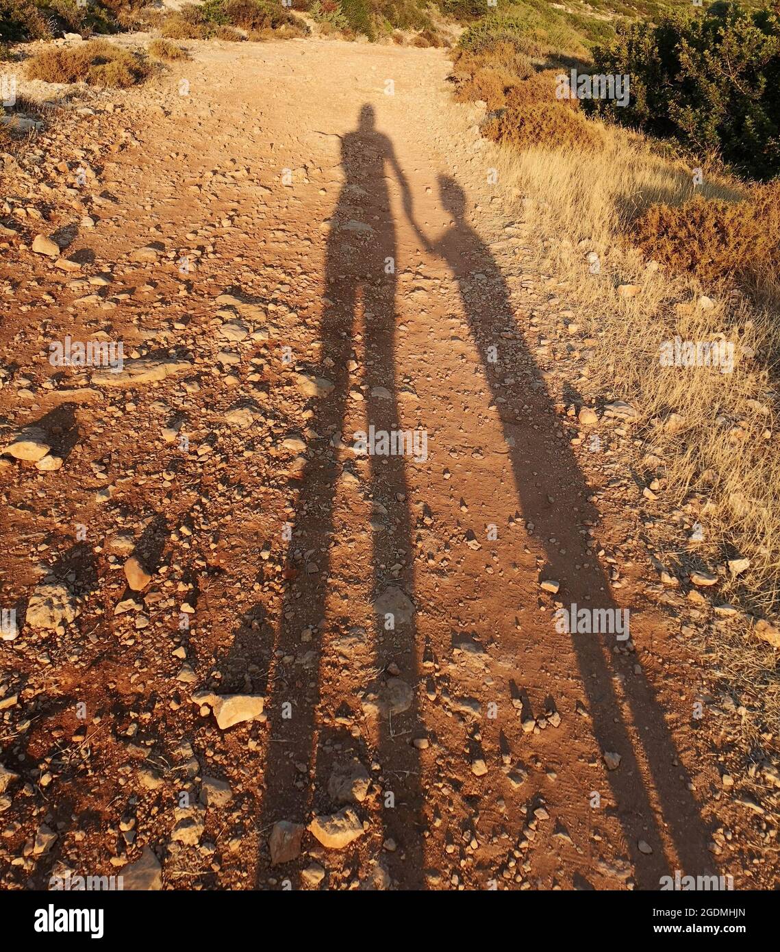Mother and son long shadows at sunset Stock Photo - Alamy