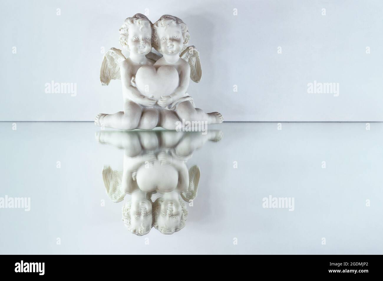 Angel figure on white background. Figure of angels with reflection ...