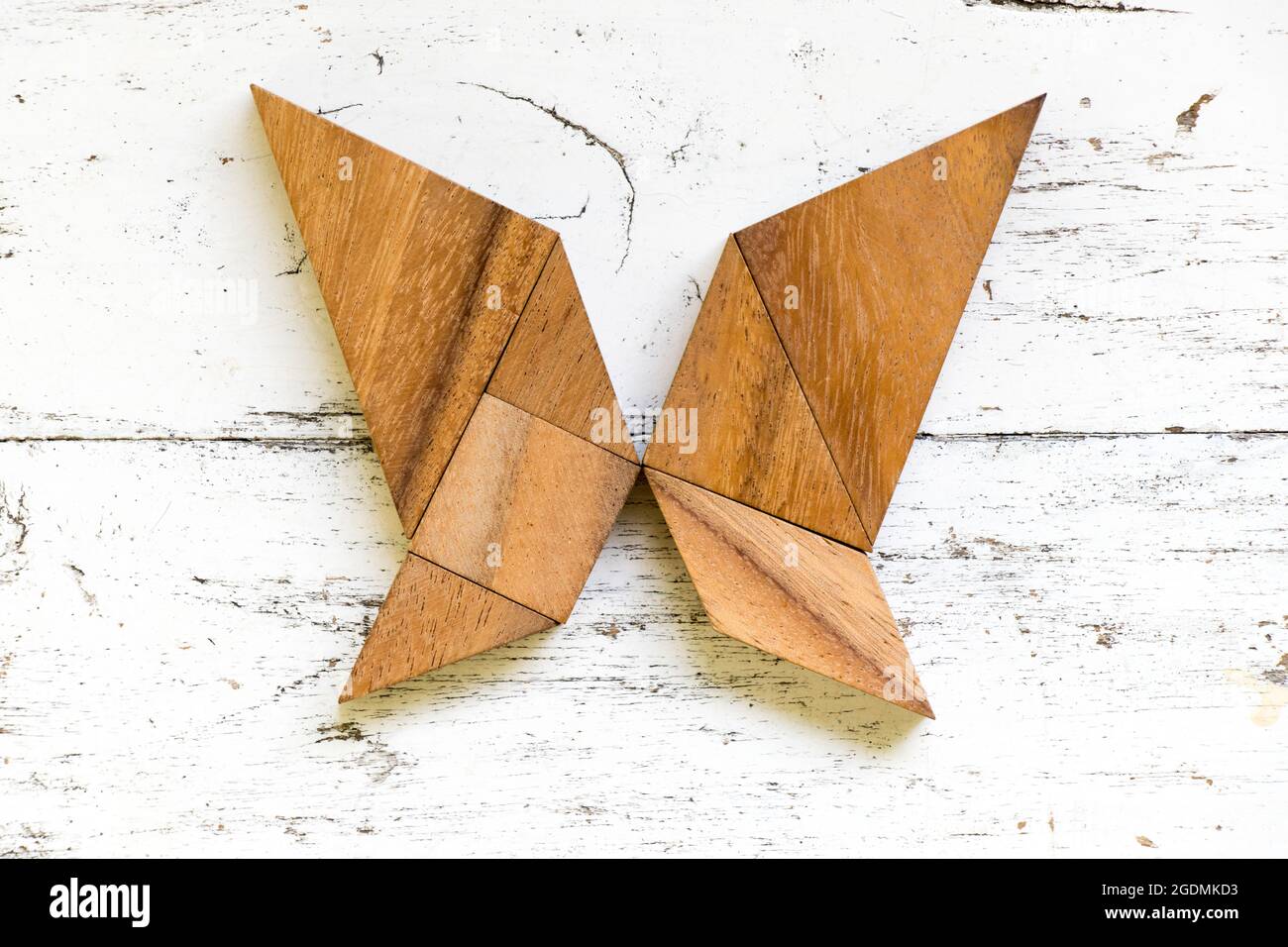 Tangram puzzle in butterfly shape on old white wood background Stock ...