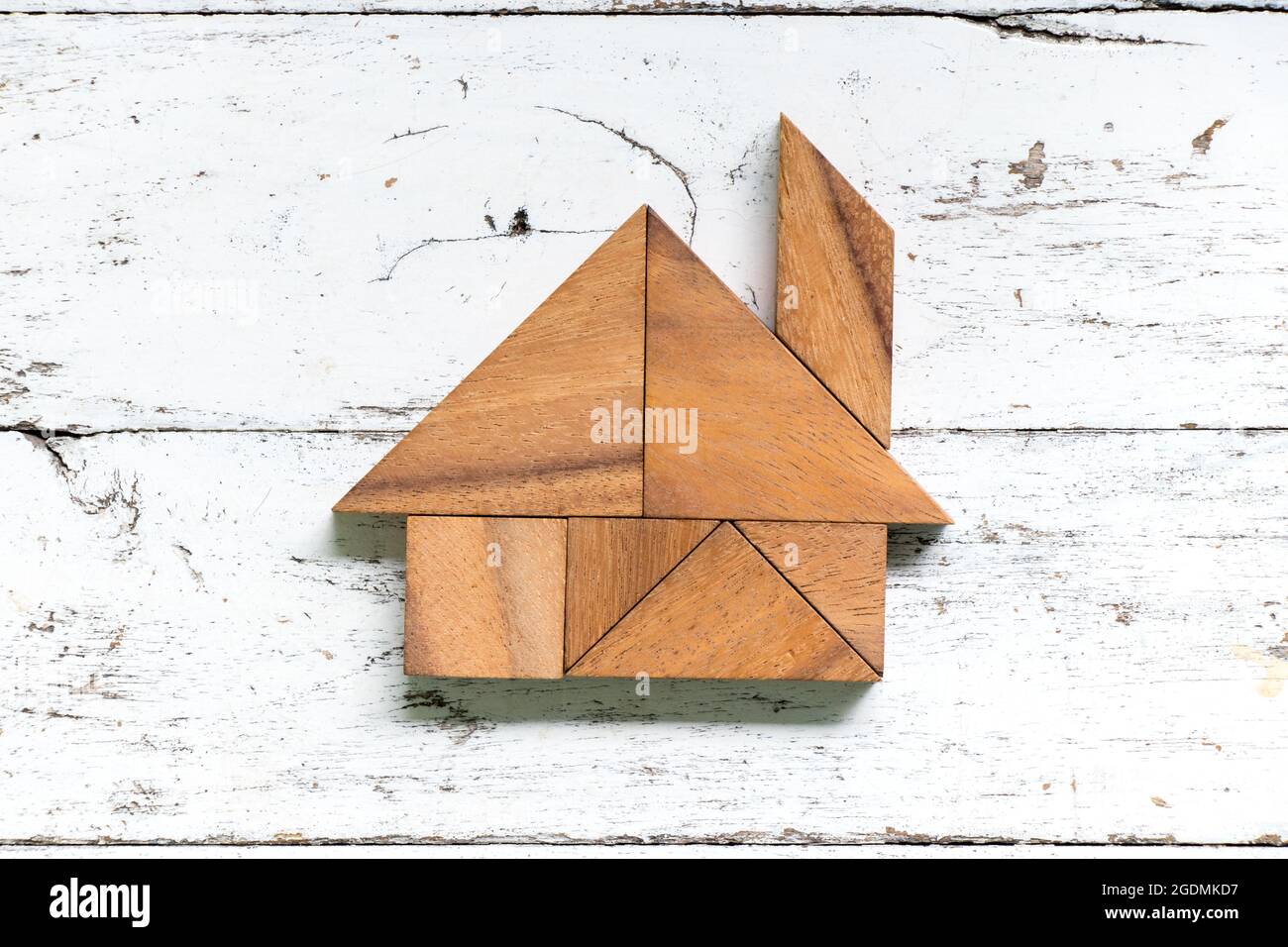 Tangram puzzle in home shape on old white wood background Stock Photo ...