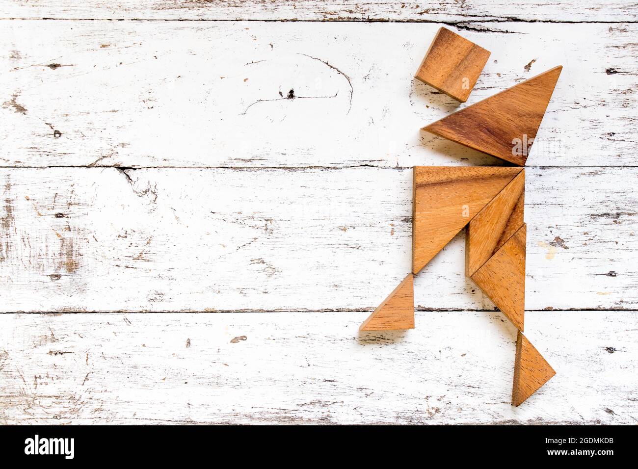 Tangram puzzle in happy dancing man shape on old white wood background ...