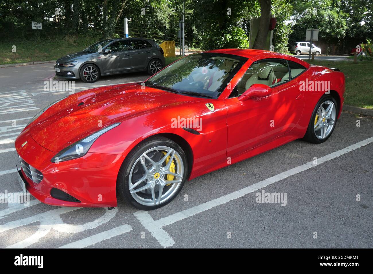 Red Ferrari sports car bright new doctors car parked in a hospital ...