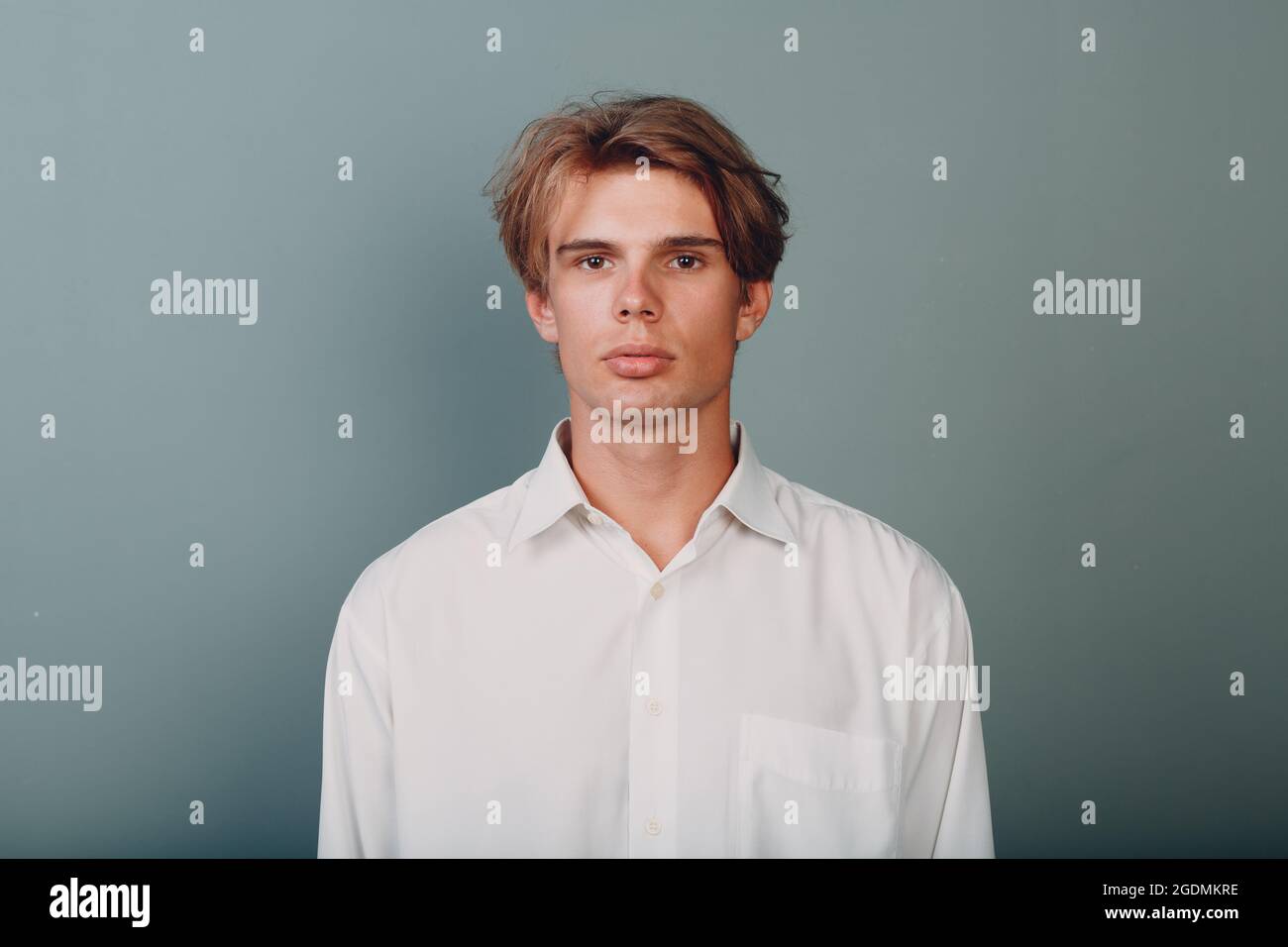 Portrait european young man serious portrait at studio Stock Photo - Alamy