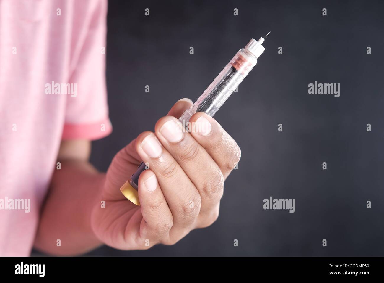 hand hold Insulin pens against black background Stock Photo - Alamy