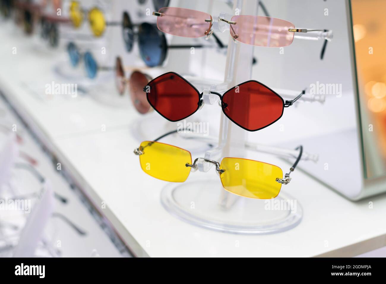 Sunglasses with colored lenses in shop window Stock Photo - Alamy