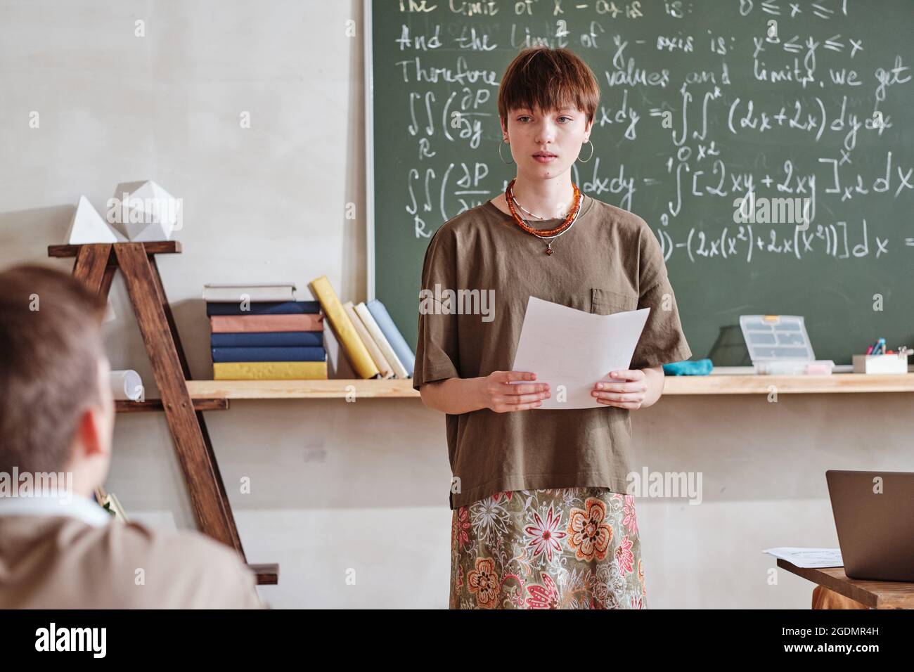 Student presenting her report to other students during lesson in the ...