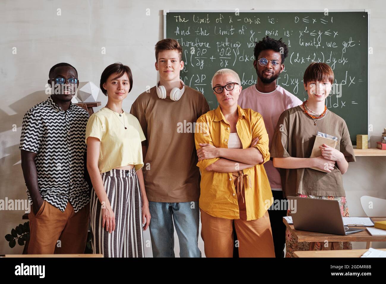 Portrait of group of students standing together with their teacher in ...