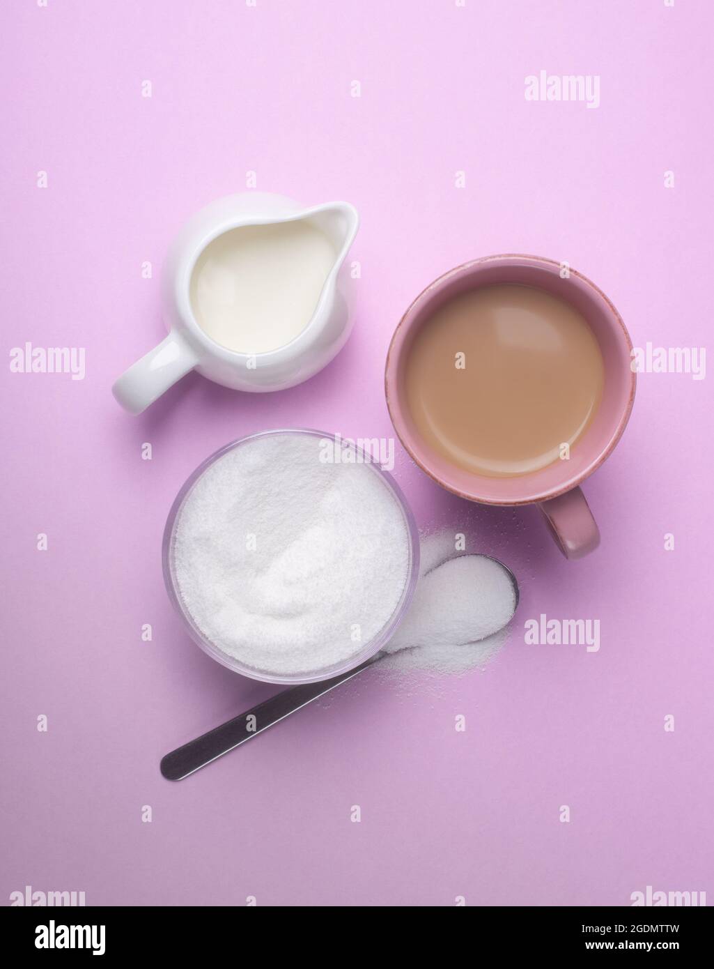 Cup with coffee with milk, milk jug and bowl with stevia on pink ...