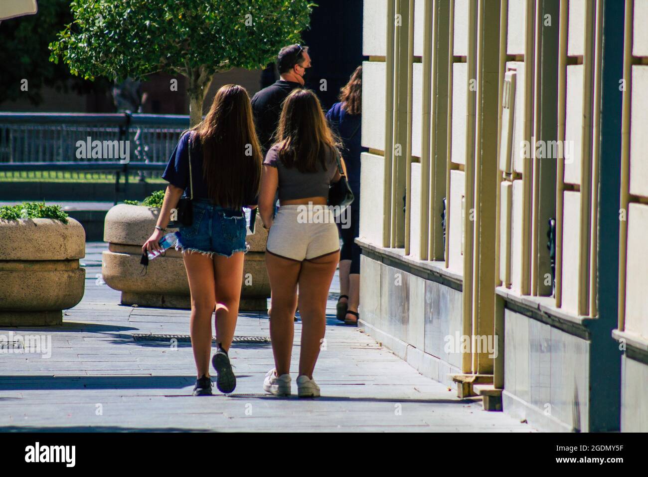 Seville Spain August 11, 2021 Tourists walking in the street of Seville ...