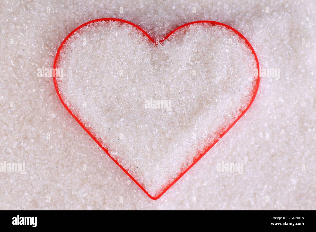 Heart covered in white sugar, close-up Stock Photo - Alamy