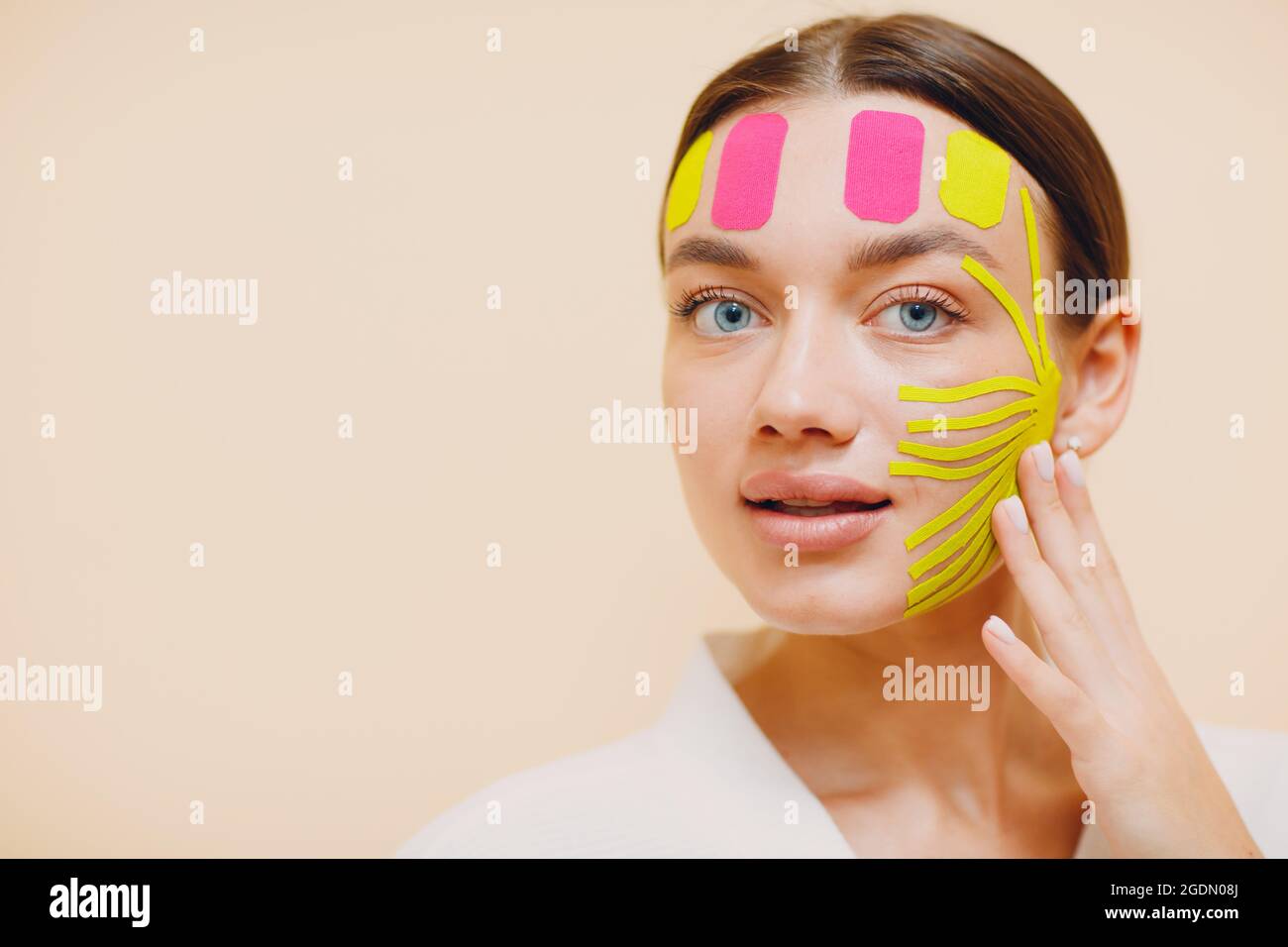 Beautiful woman applying tape lifting treatment procedure on face Stock ...