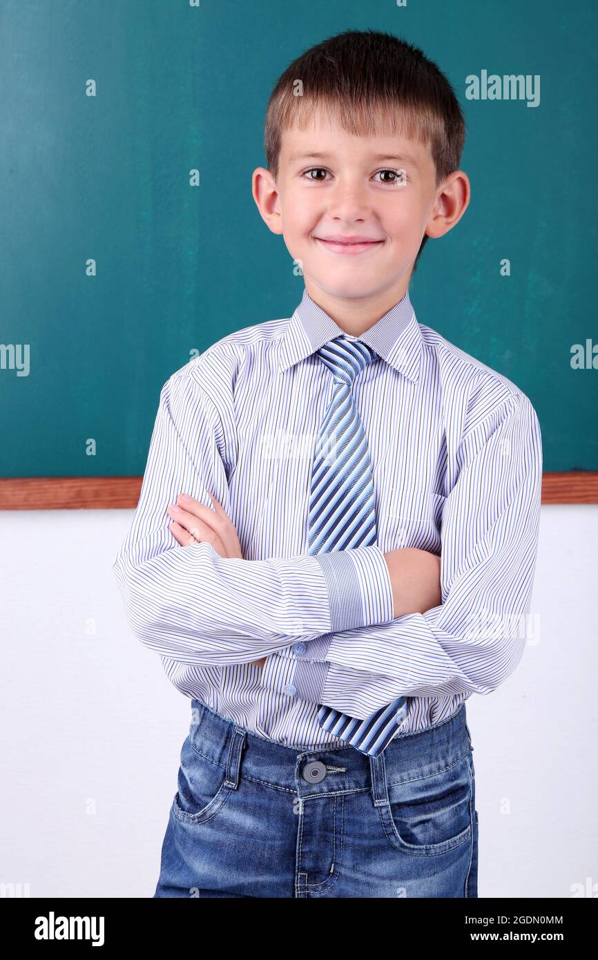 Schoolboy at blackboard in classroom Stock Photo - Alamy