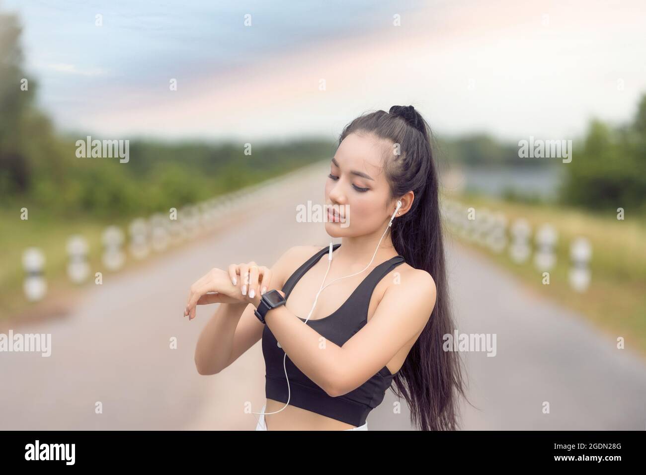 Female runner using smart watch,Young Woman Checking Heart Rate On ...