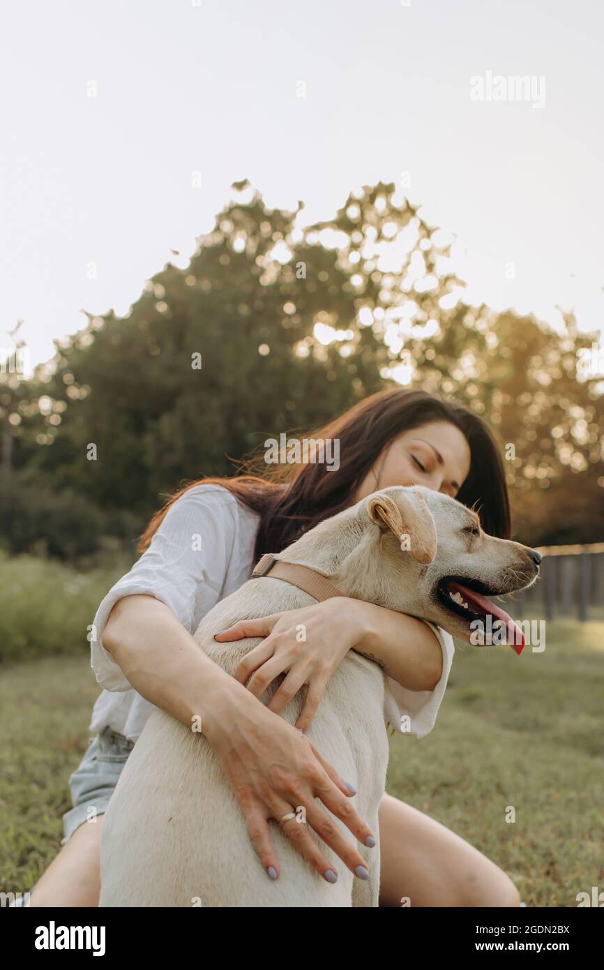 Smiling girl hugging labrador hi-res stock photography and images - Alamy