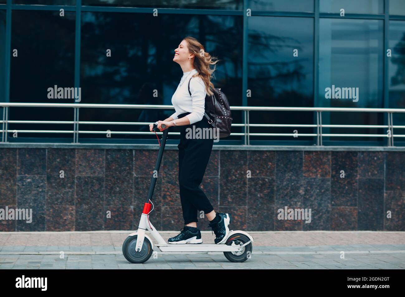 Young woman enjoying riding electric scooter at the city Stock Photo ...