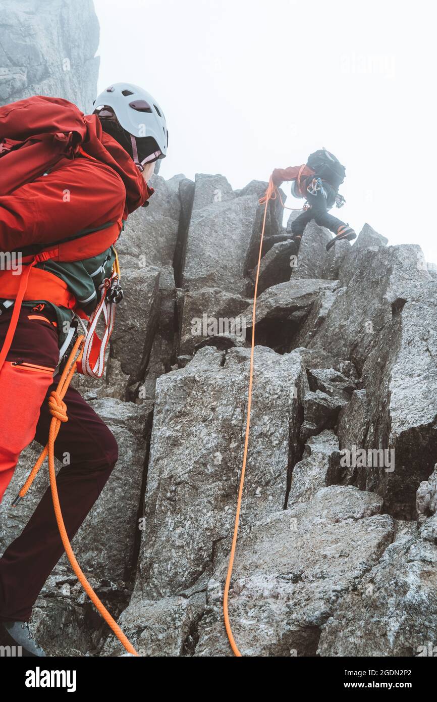 High Alpine mountain guide ascending granite ridge near Mont Blanc ...