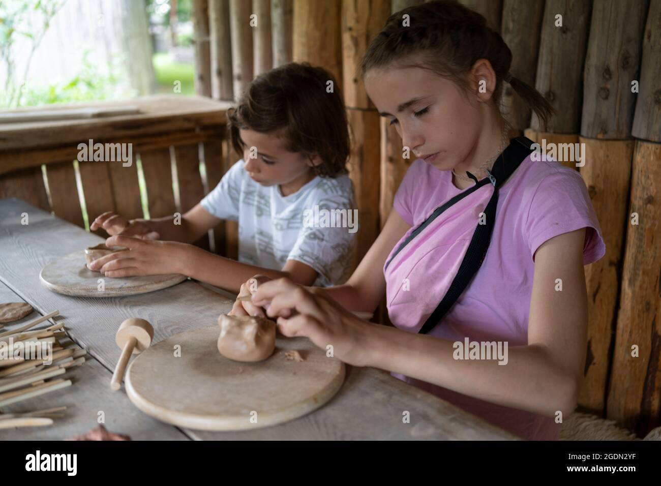two young kids modelling clay Stock Photo - Alamy