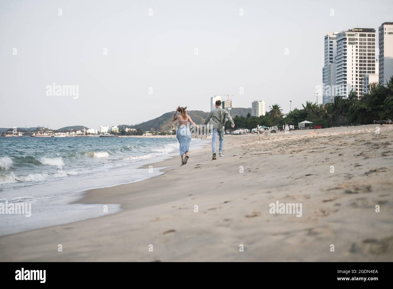 Romantic Couple Walking On Beautiful Tropical Beach. Back side view ...