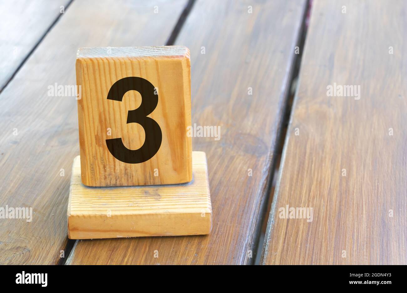 Wooden priority number 3 on a plank tab Stock Photo - Alamy