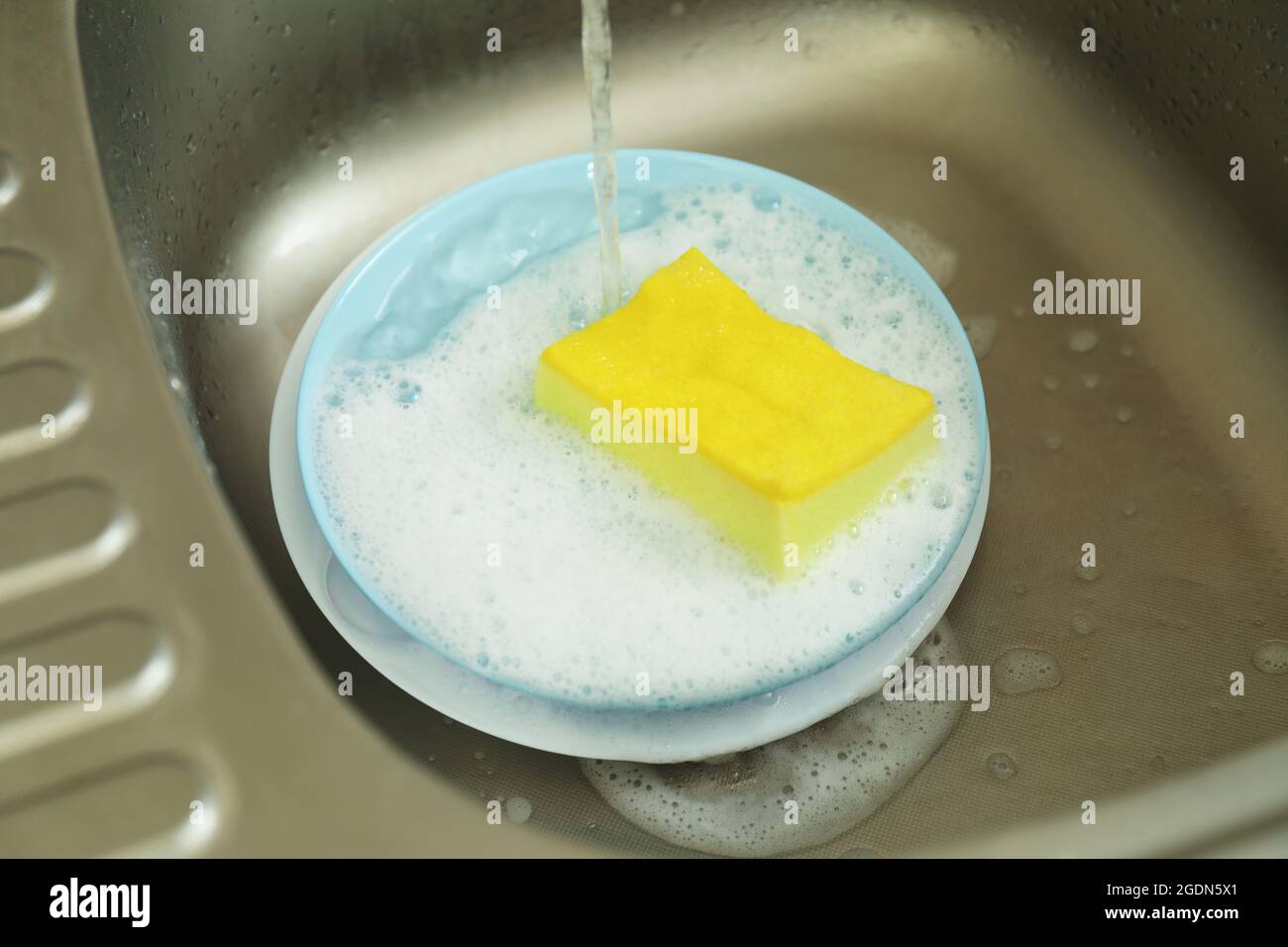 Concept of dishwashing on kitchen basin background Stock Photo - Alamy
