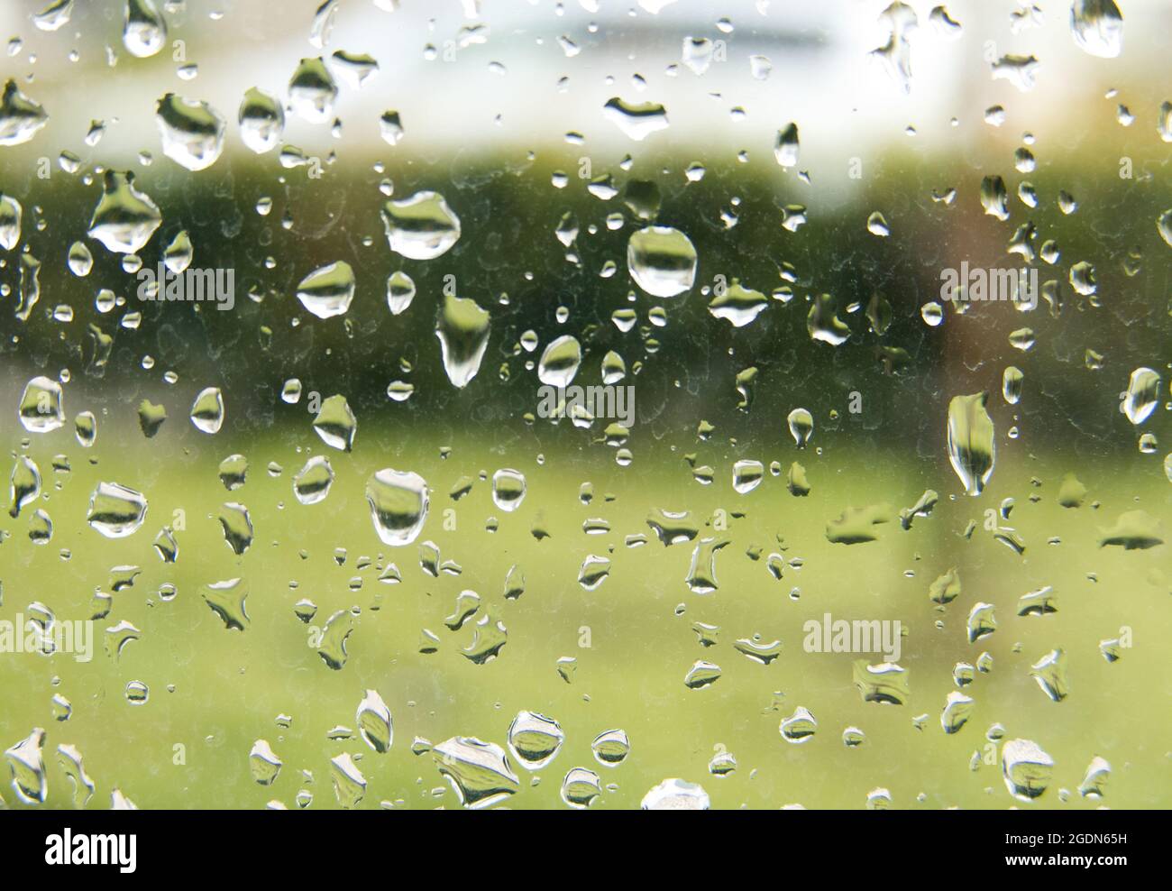 Rain droplets on a window pane, looking out Stock Photo - Alamy